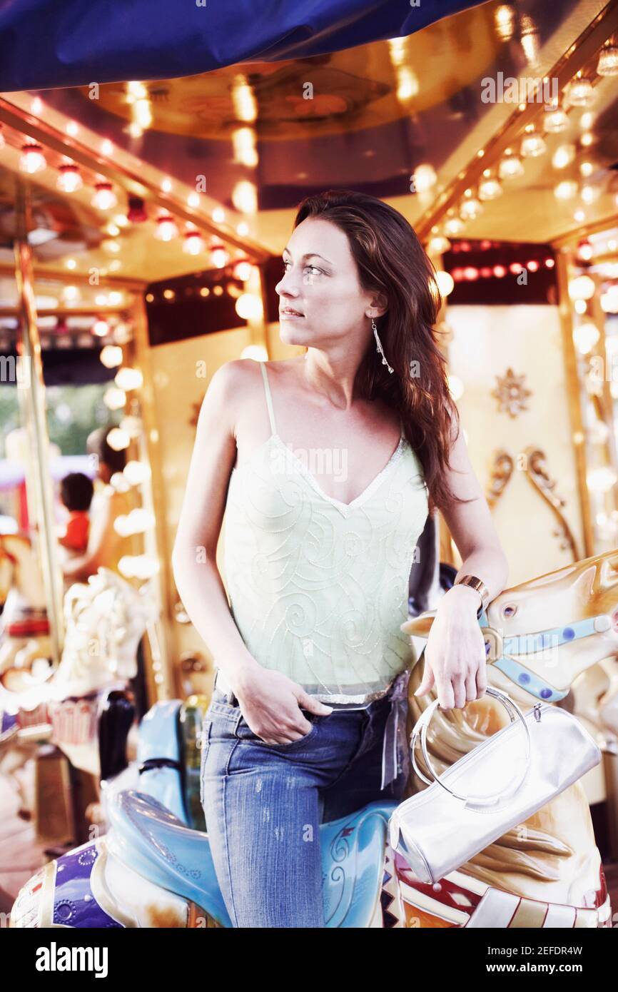 Young woman riding a carousel horse Stock Photo - Alamy