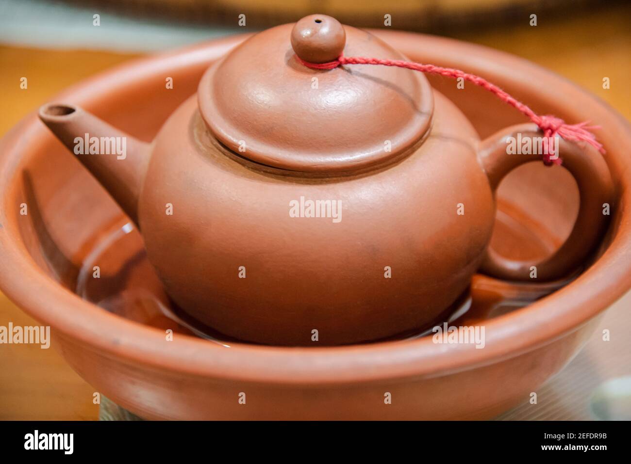traditional chinese tea cup in a bowl with brown color Stock Photo - Alamy