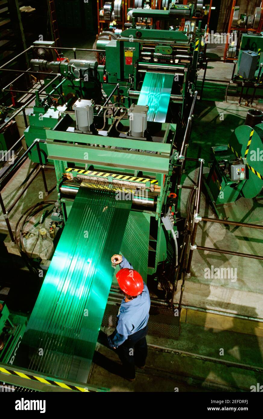 High angle view of a worker standing in a production line of a steel ...
