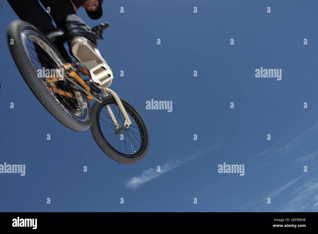 Low angle view of a young man jumping with his bicycle Stock Photo - Alamy