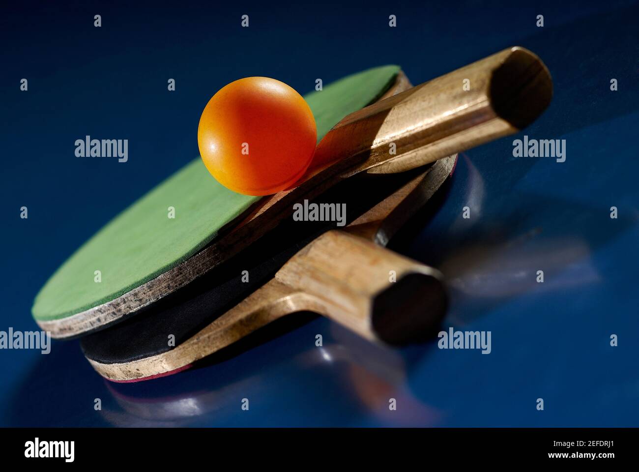 Two table tennis rackets with a ball on a table tennis table Stock ...