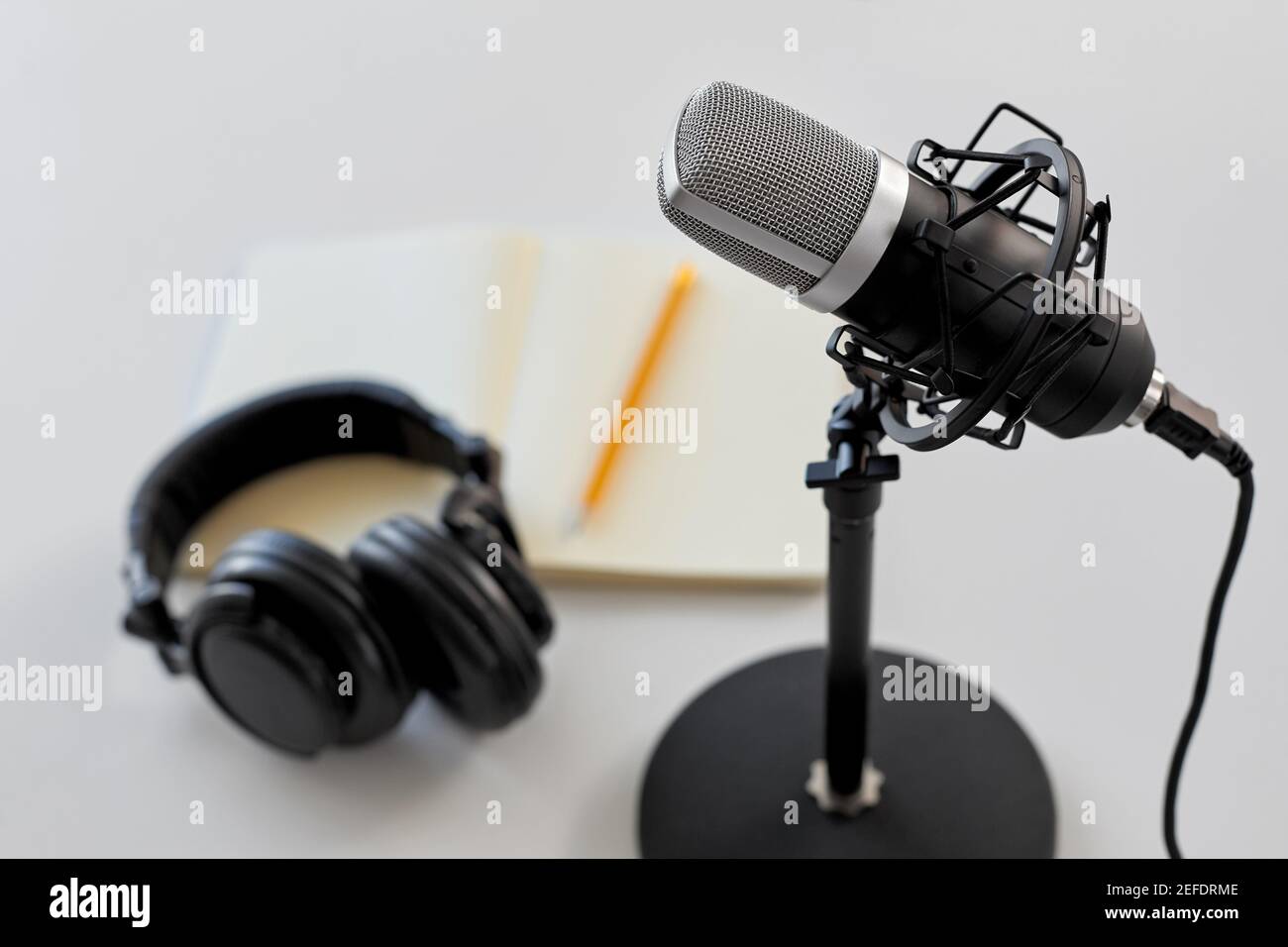 headphones, microphone and notebook with pencil Stock Photo - Alamy