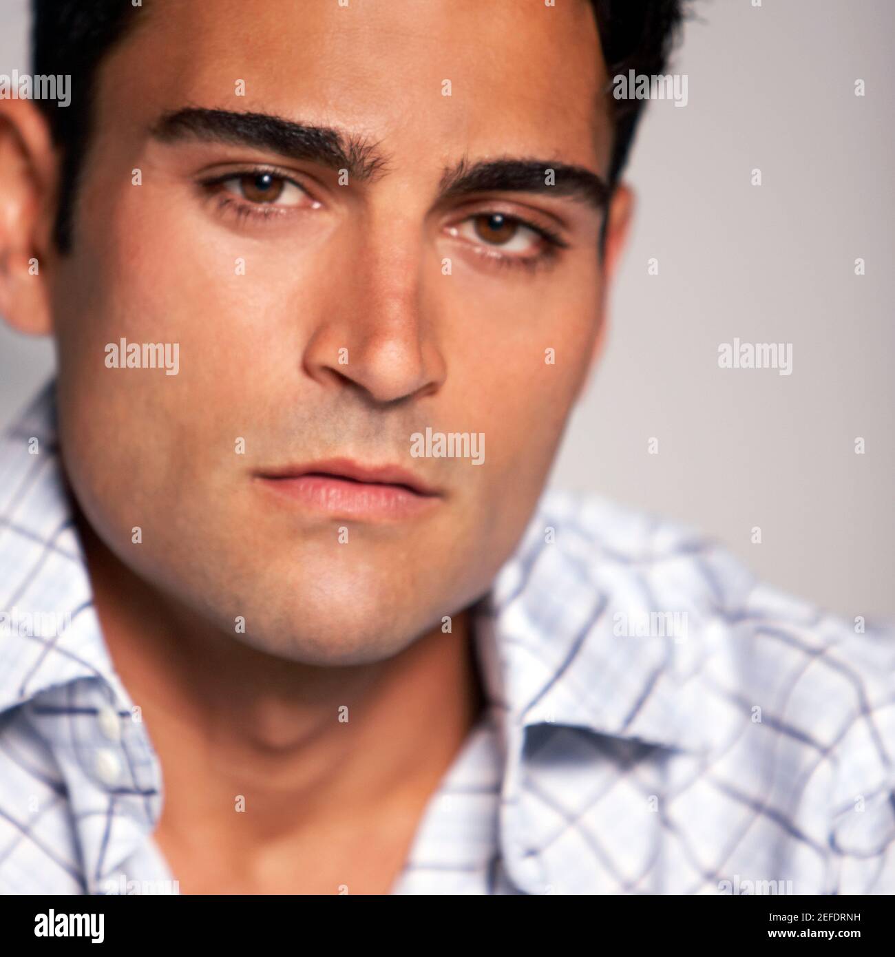 Portrait of a young man looking serious Stock Photo - Alamy