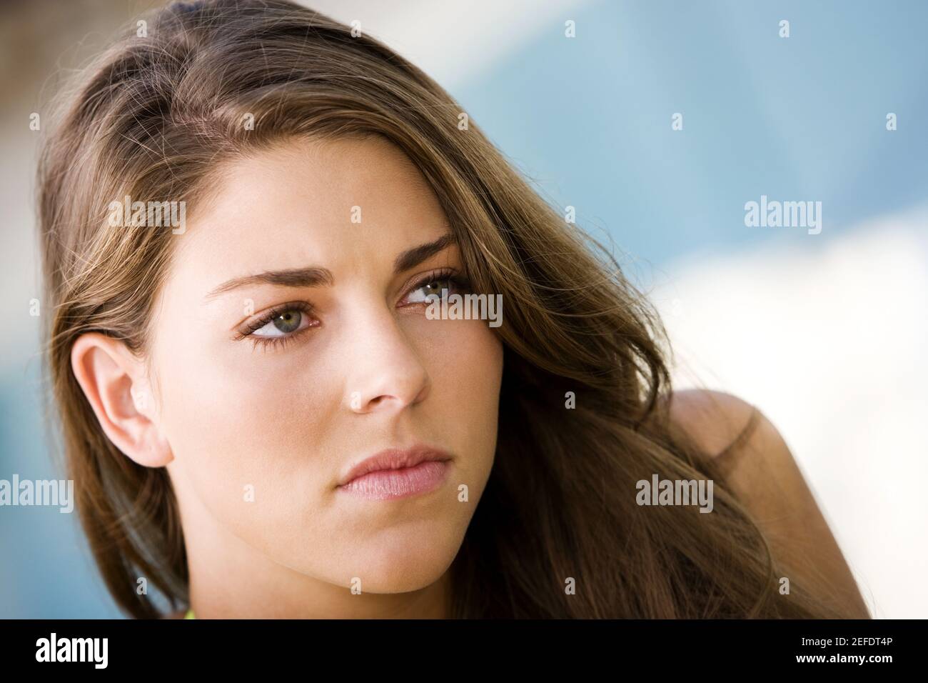 Close-up of a young woman thinking Stock Photo - Alamy