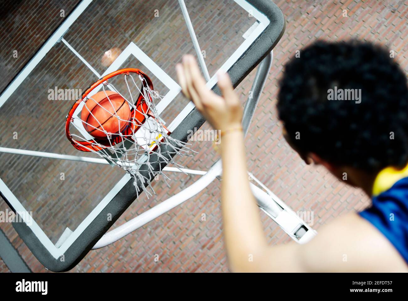 Rear view of a man playing basketball Stock Photo - Alamy