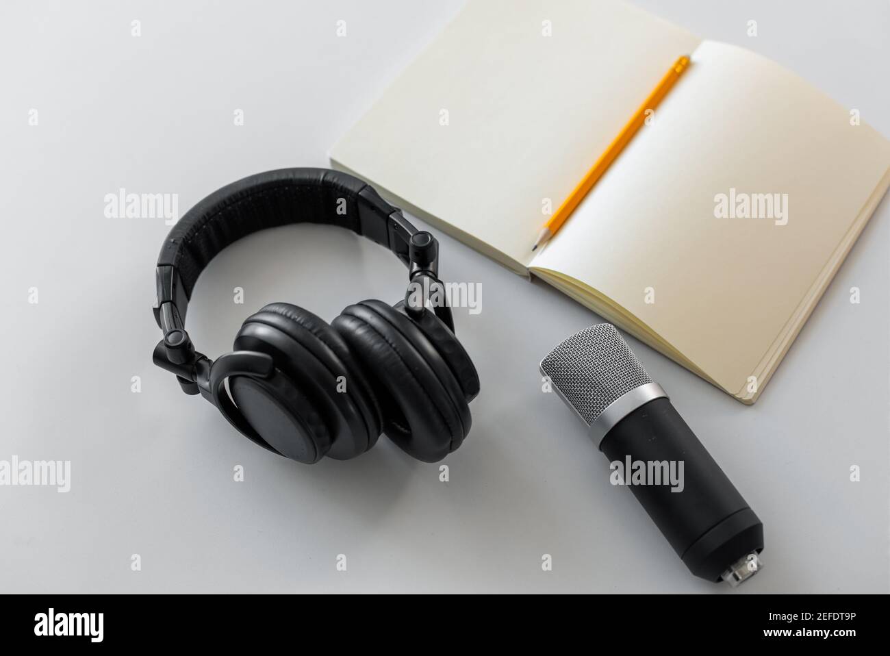 headphones, microphone and notebook with pencil Stock Photo - Alamy