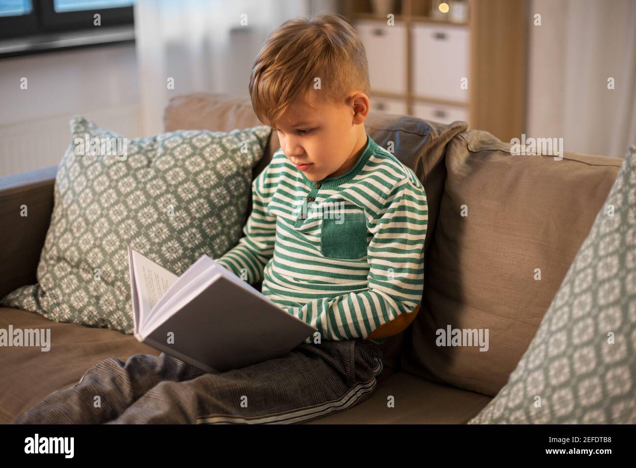 little boy reading book at home Stock Photo - Alamy