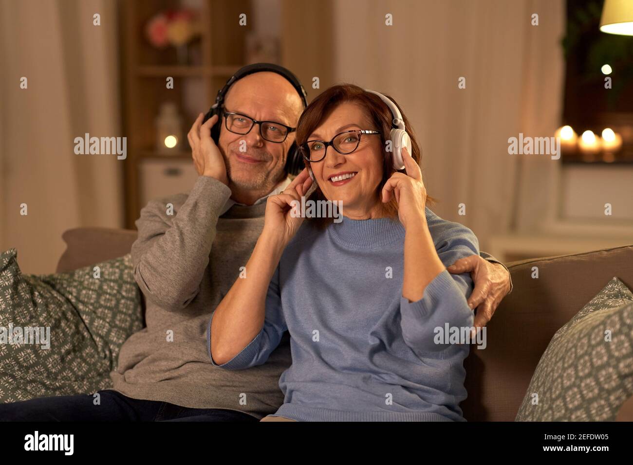 Beautiful couple listening music headphones hi-res stock photography ...