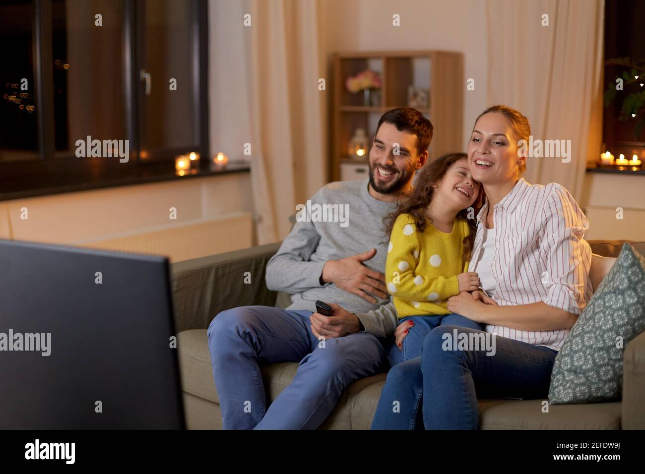 happy family watching tv at home at night Stock Photo - Alamy