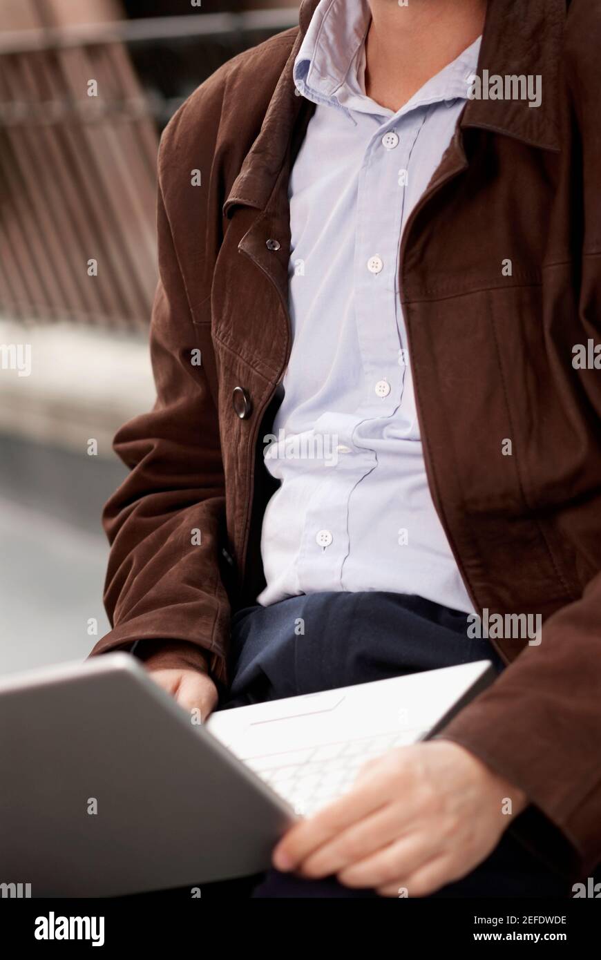 Mid section view of a businessman using a laptop Stock Photo - Alamy