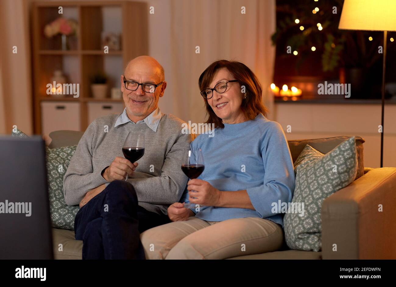 happy senior couple drink red wine and watch tv Stock Photo - Alamy