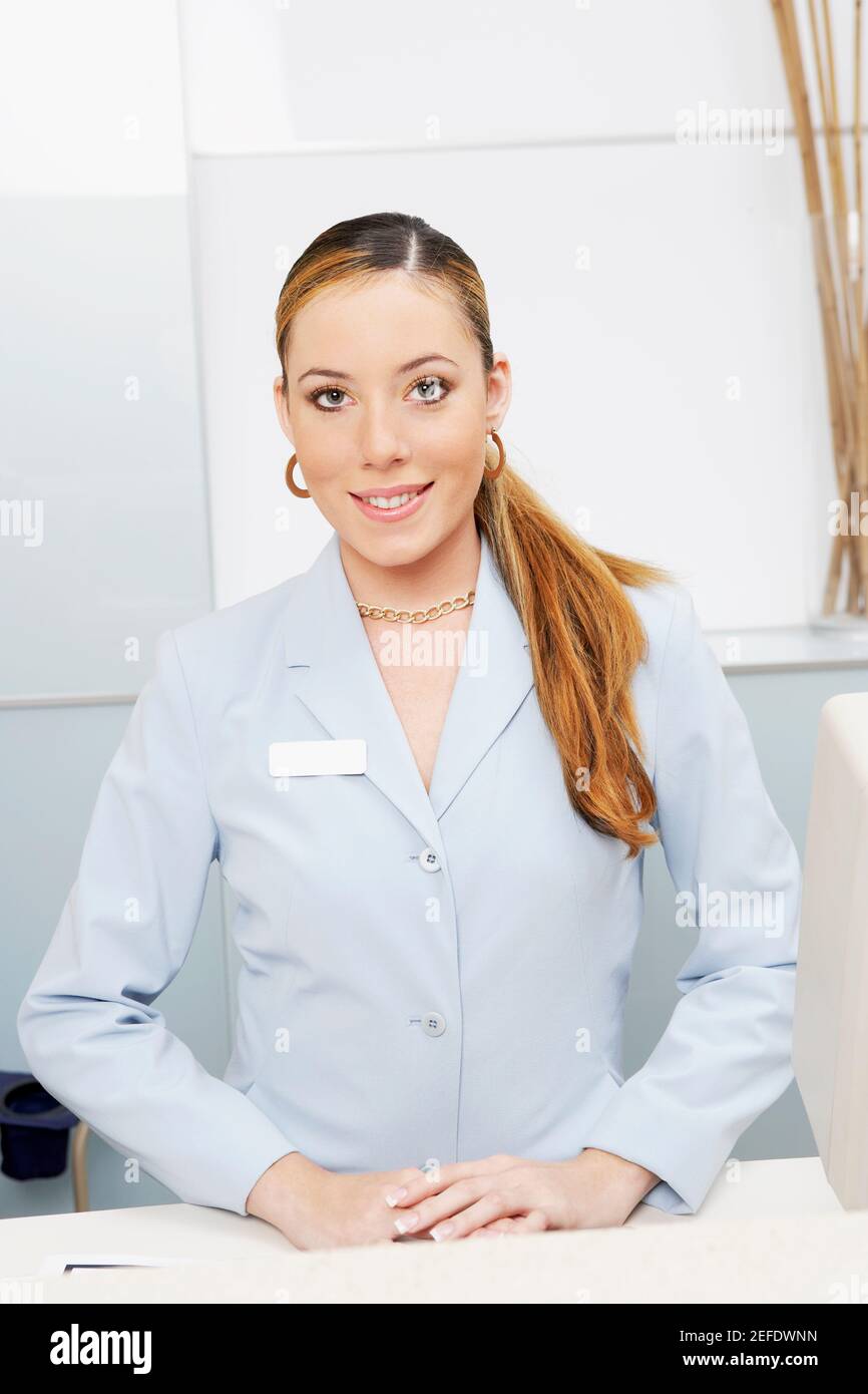 Portrait female hotel receptionist standing hi-res stock photography and images - Alamy