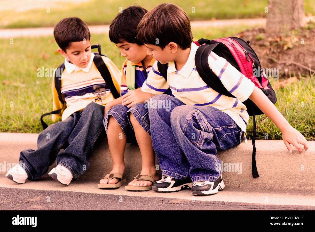 Three schoolboys sitting together Stock Photo - Alamy