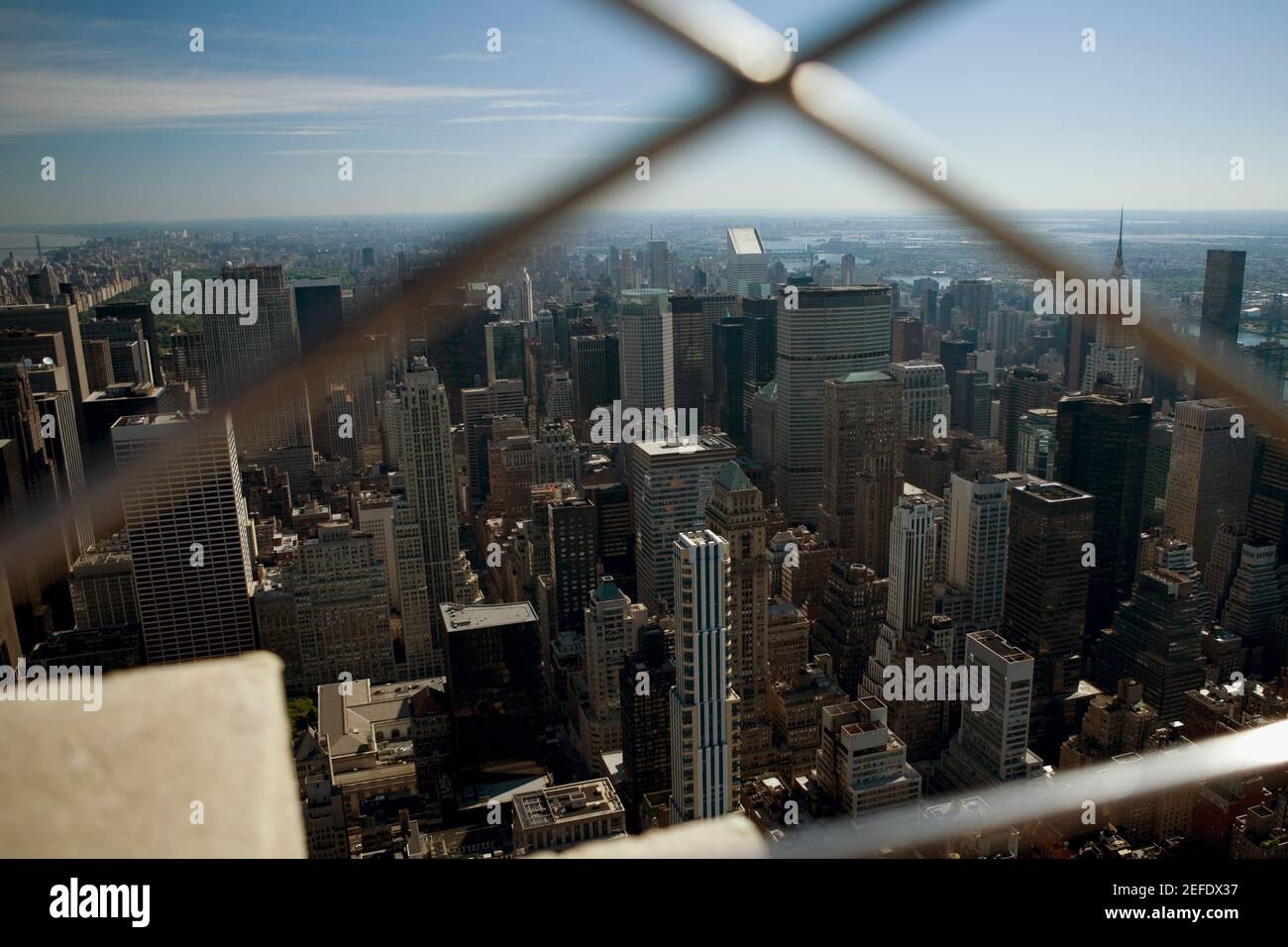 Aerial view of buildings seen through a window grill, New York City ...