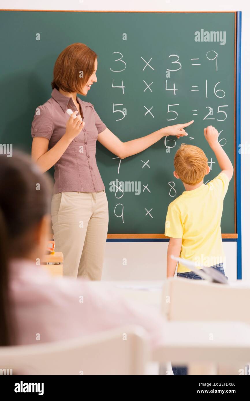 Female teacher teaching her student in a classroom Stock Photo - Alamy