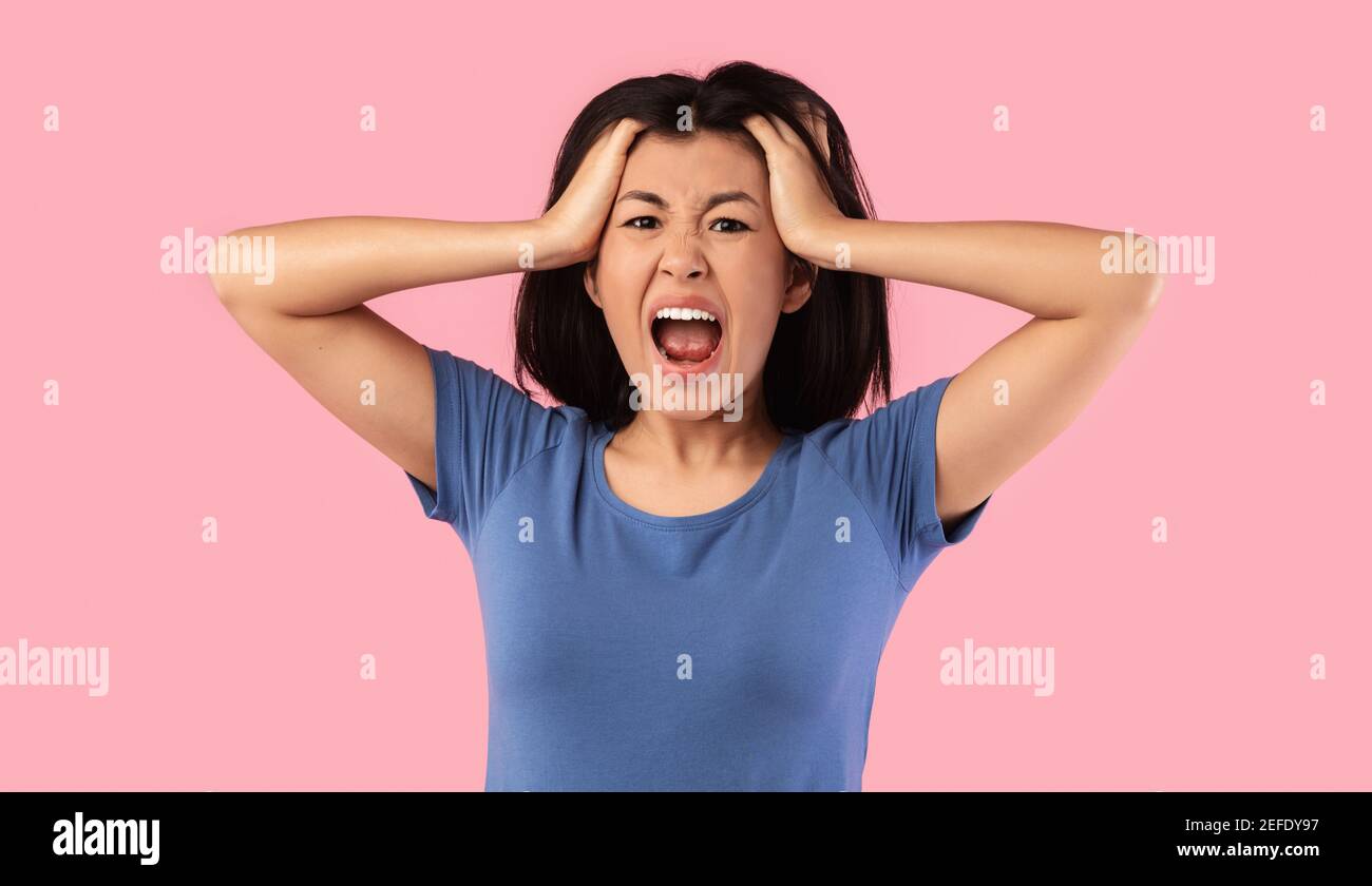 Reactions Concept. Angry asian woman shouting and grabbing head ...