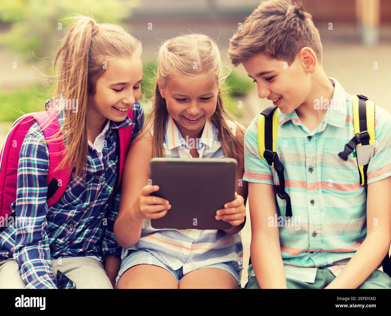group of happy elementary school students talking Stock Photo - Alamy