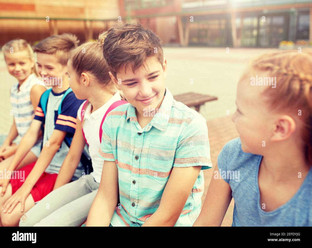 group of happy elementary school students talking Stock Photo - Alamy