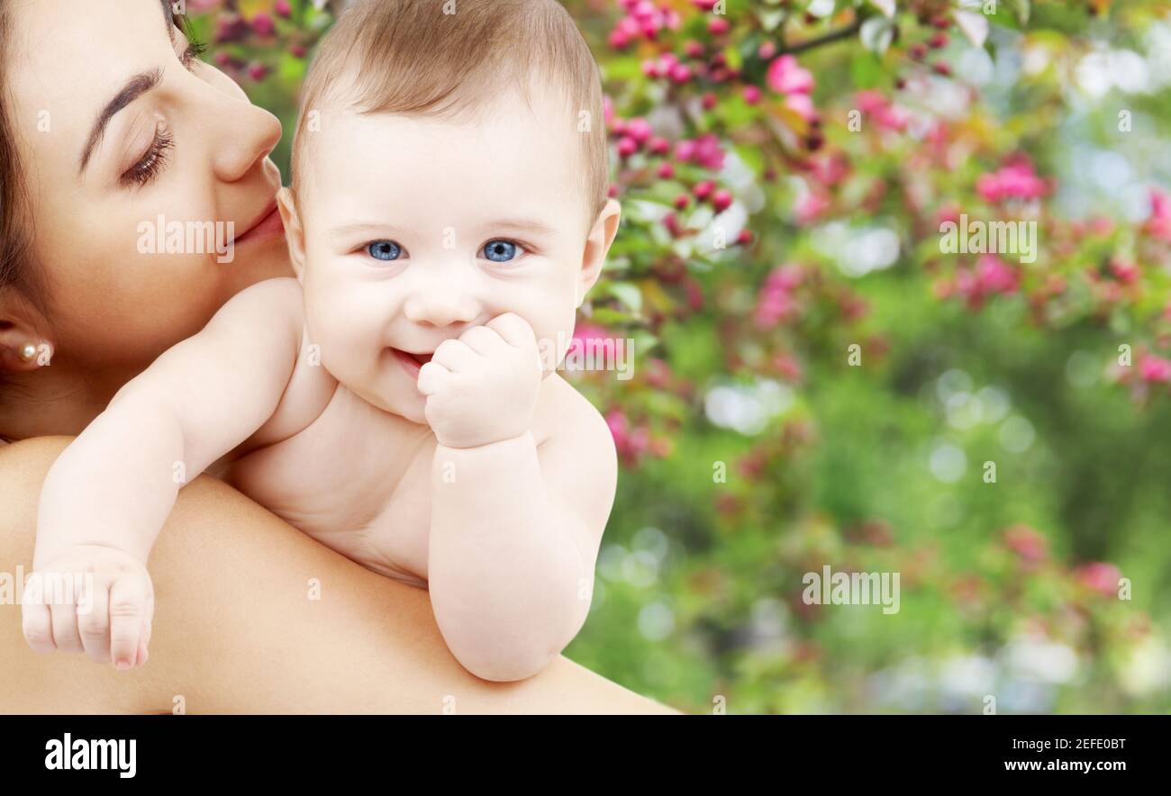mother with baby over spring garden background Stock Photo - Alamy
