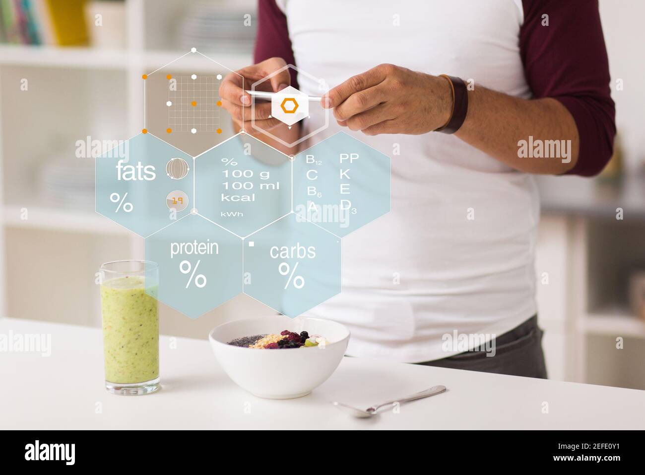 hands with phone and food nutritional value chart Stock Photo - Alamy