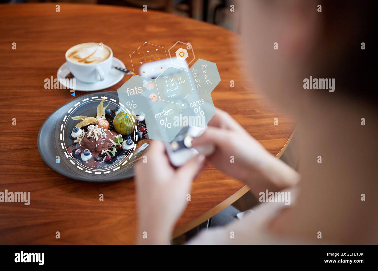 hands with phone and food nutritional value chart Stock Photo - Alamy