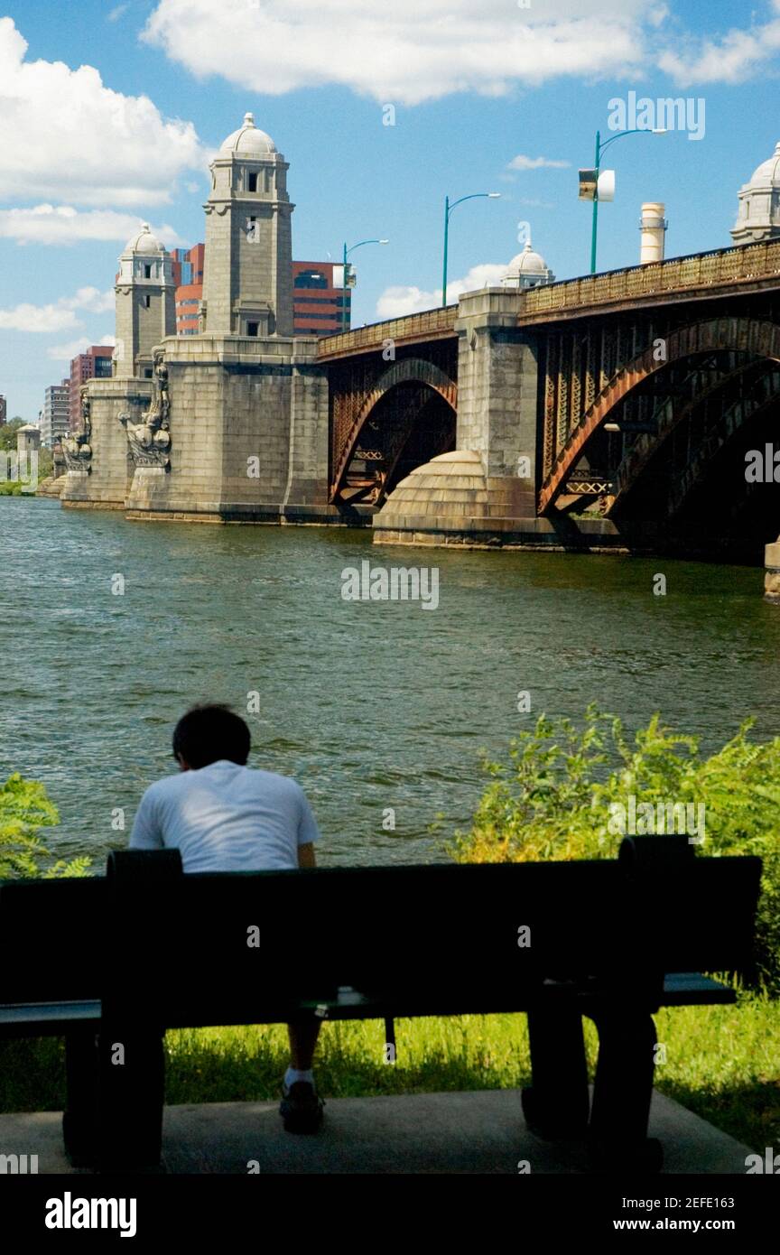 Man sitting bench building arch hi-res stock photography and images - Alamy