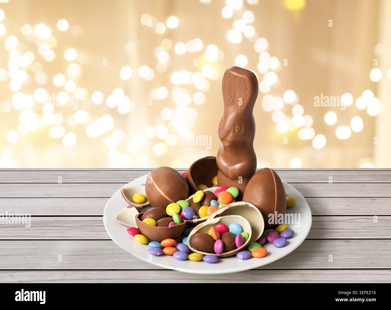chocolate bunny, eggs and candies over lights Stock Photo - Alamy