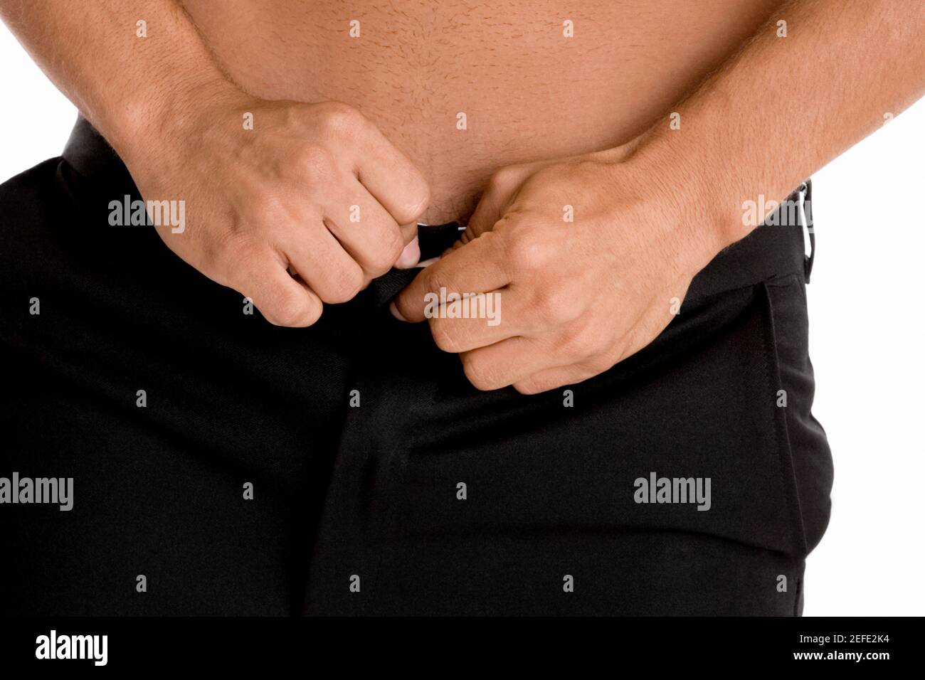 Mid section view of a man buttoning his pants Stock Photo - Alamy
