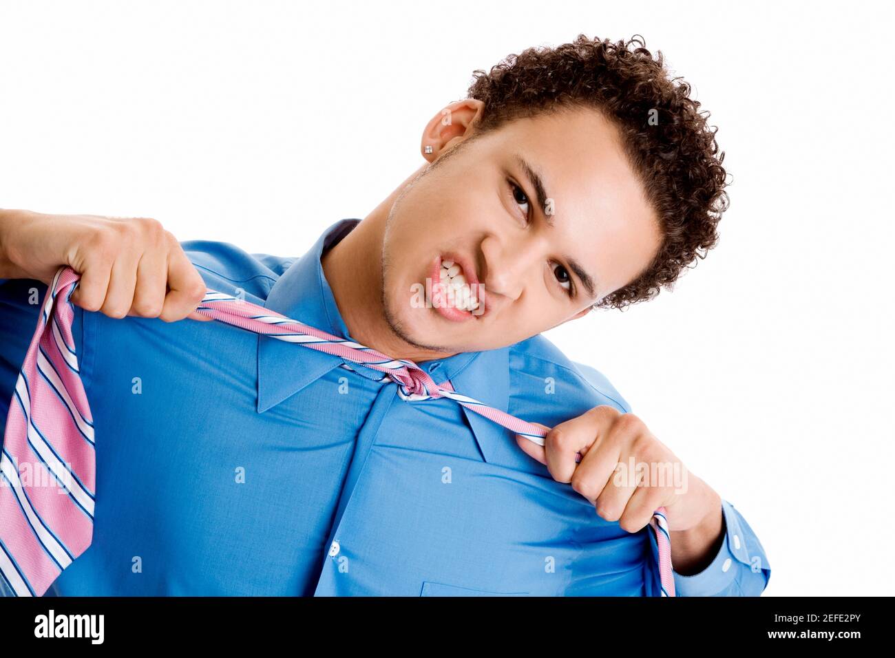 Portrait of a young man pulling his tie Stock Photo - Alamy