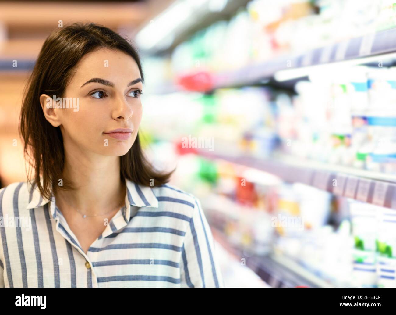 Lady in grocery store with shopping cart full of groceries hi-res stock ...