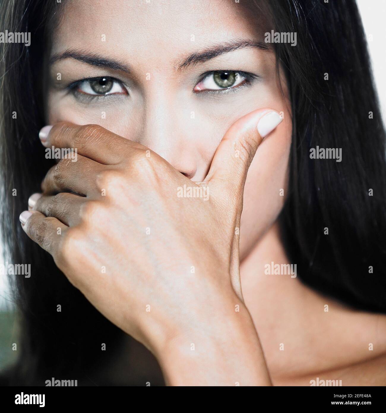 Portrait of a young woman with her hand in front of her face Stock ...