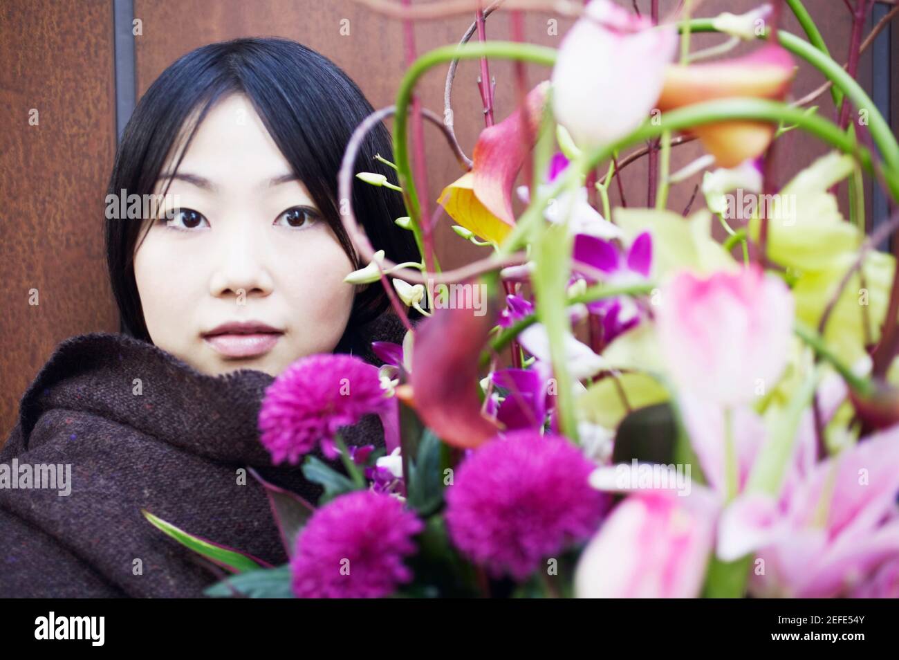 Young woman behind a flower hi-res stock photography and images - Alamy