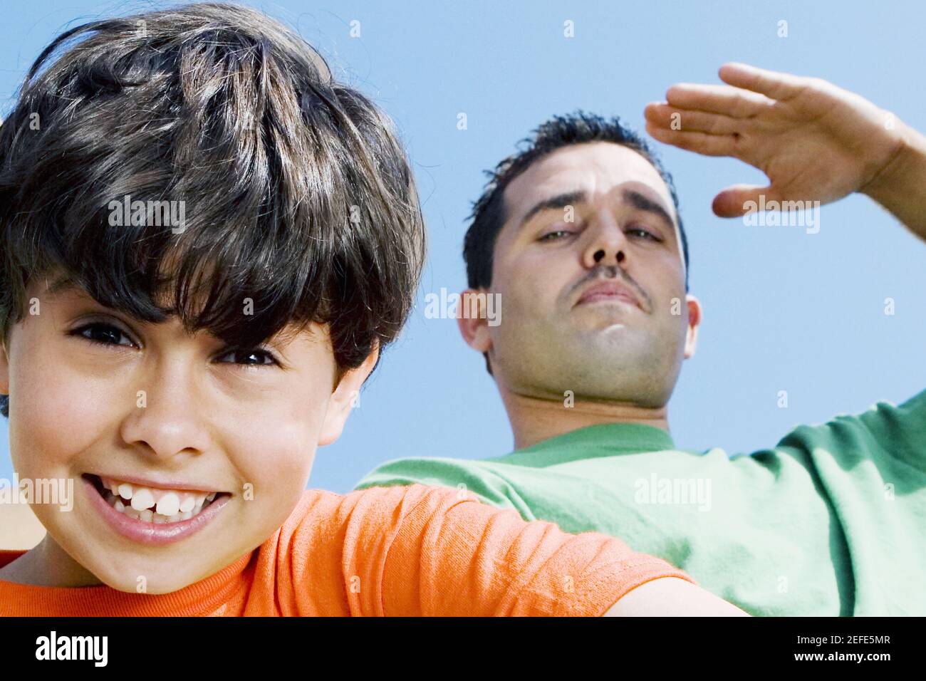 Portrait of a boy smiling with his father behind him Stock Photo - Alamy