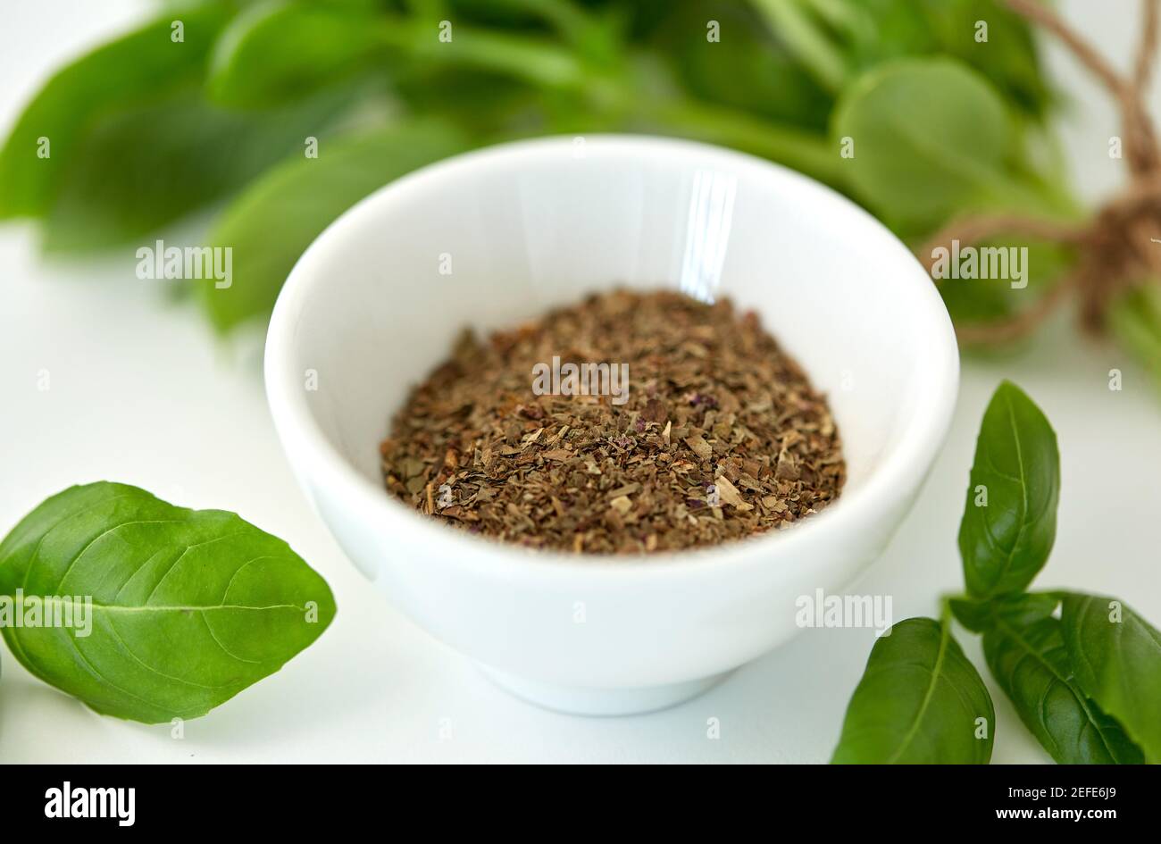 fresh basil and dry seasoning on white background Stock Photo - Alamy