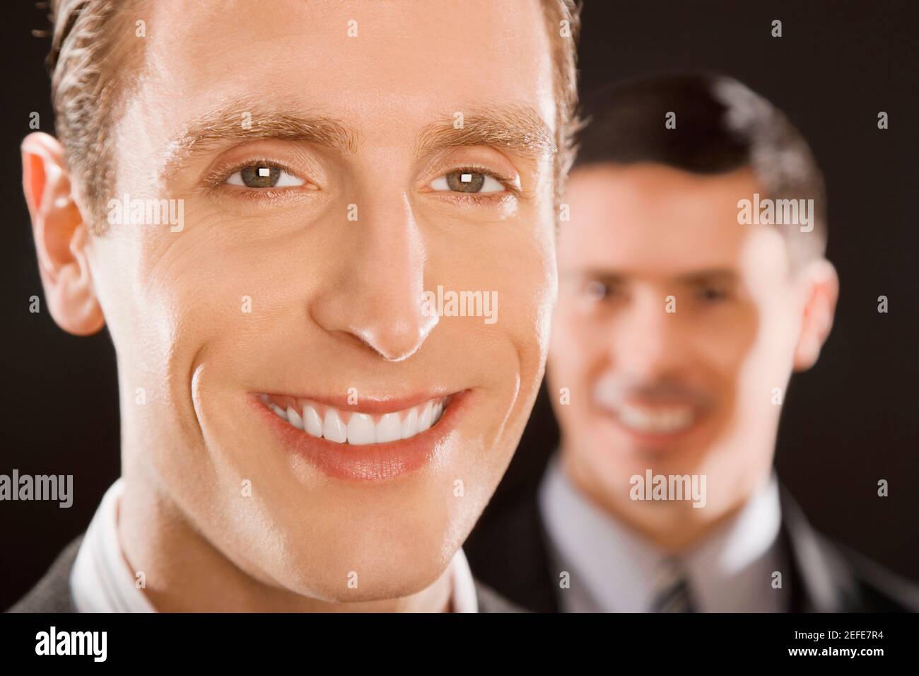 Portrait of two businessmen smiling Stock Photo - Alamy