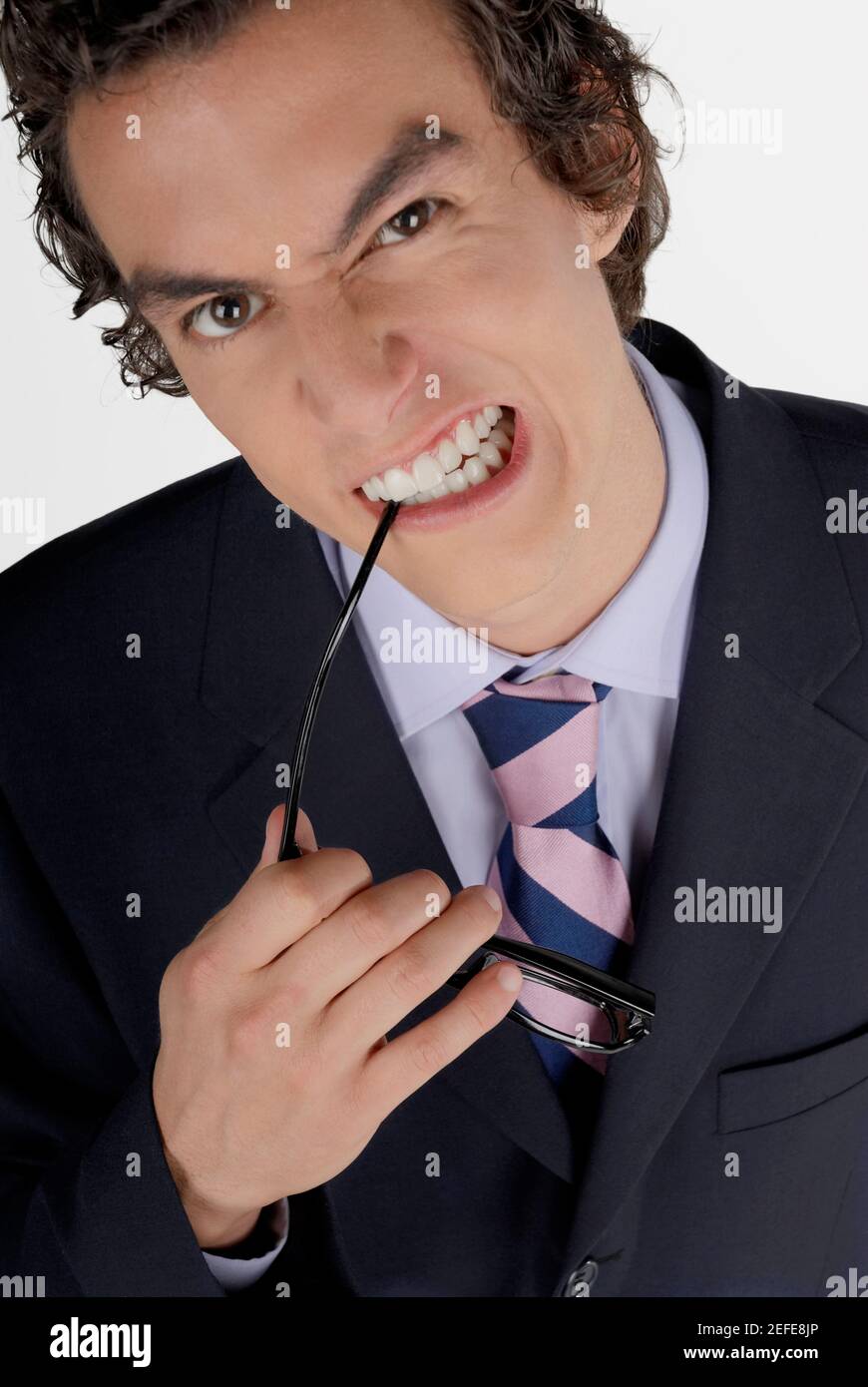 Portrait of a businessman biting his sunglasses Stock Photo - Alamy