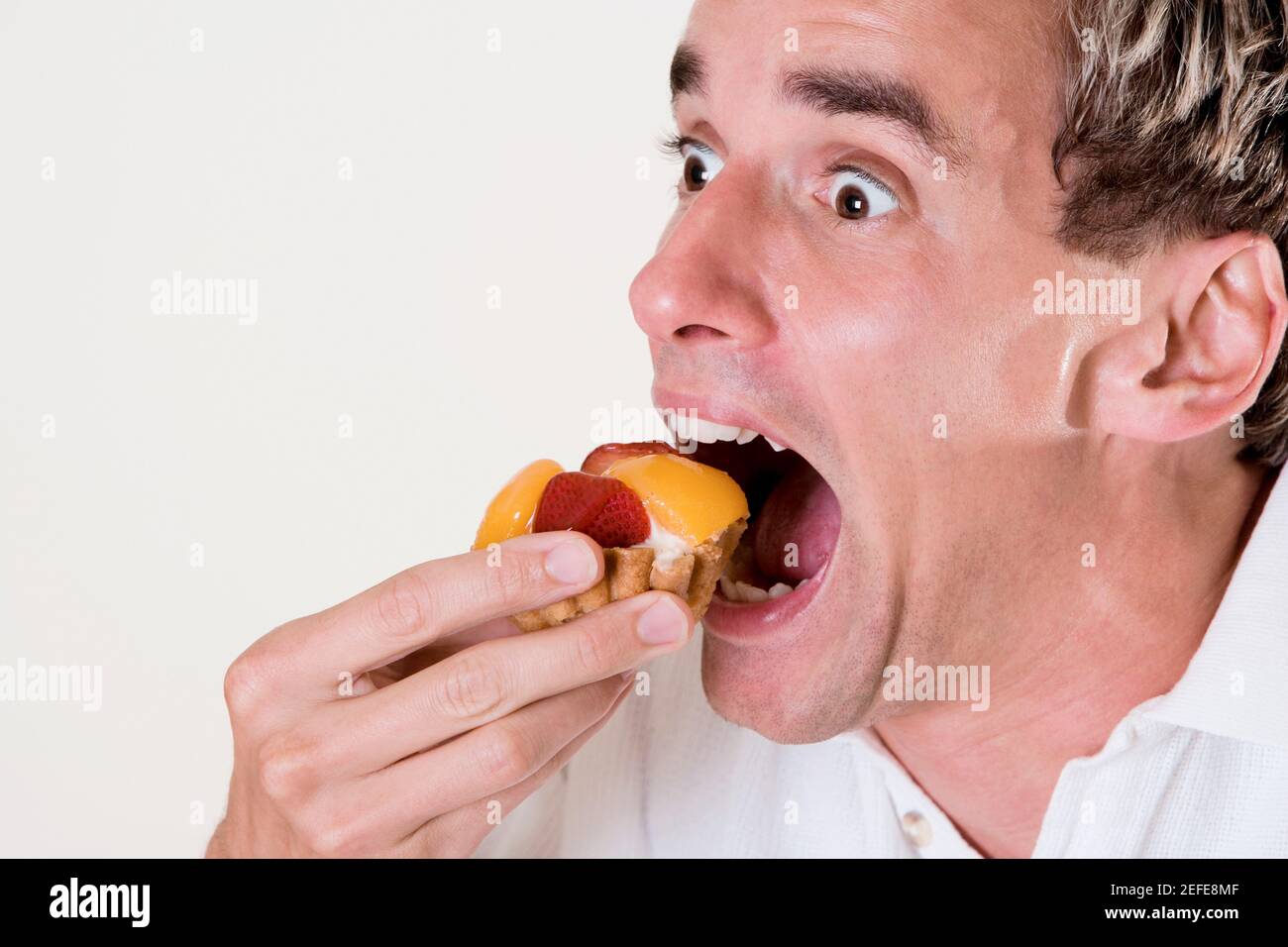 Male eating fruit with open mouth hi-res stock photography and images ...