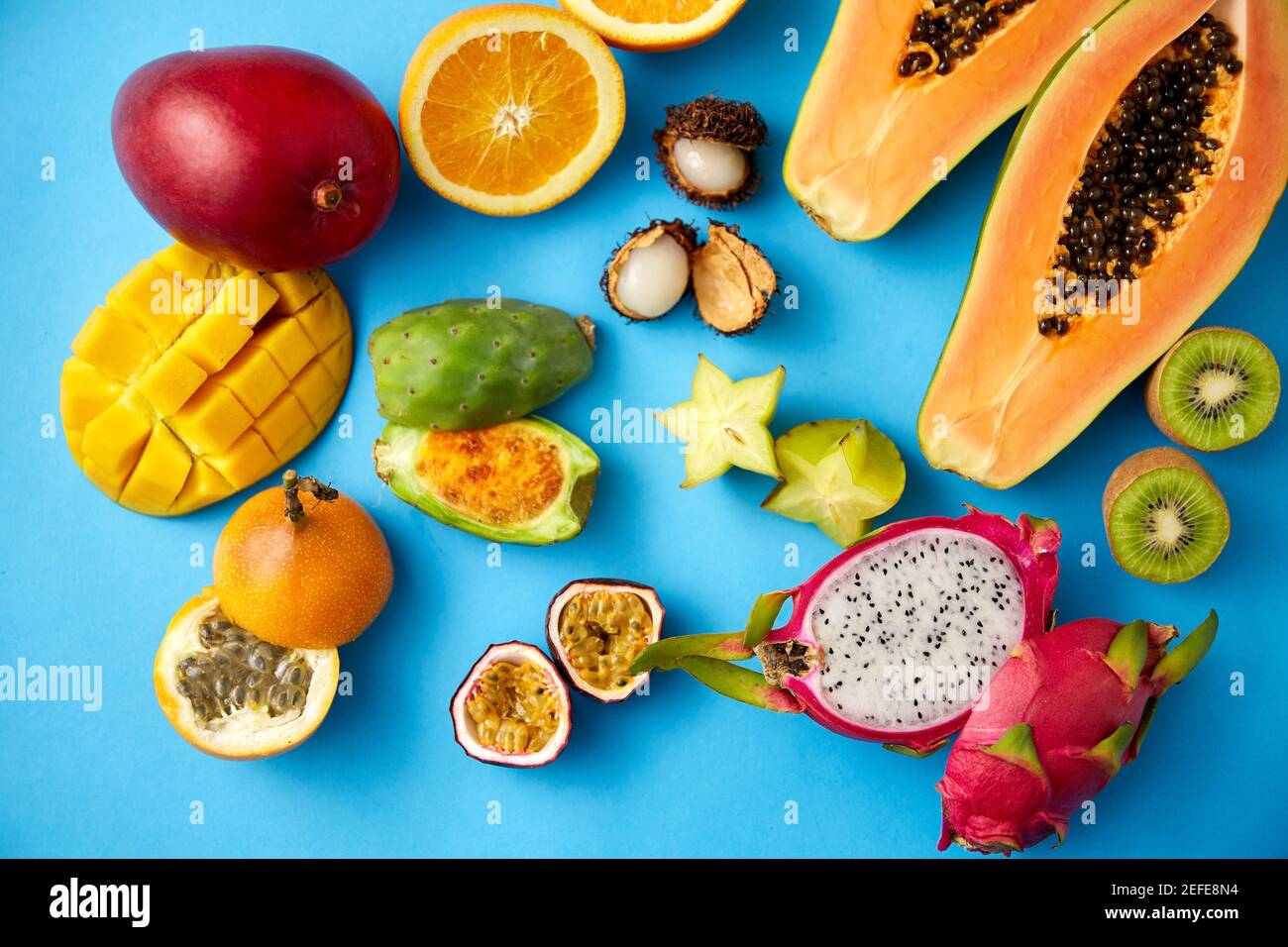 different exotic fruits on blue background Stock Photo - Alamy