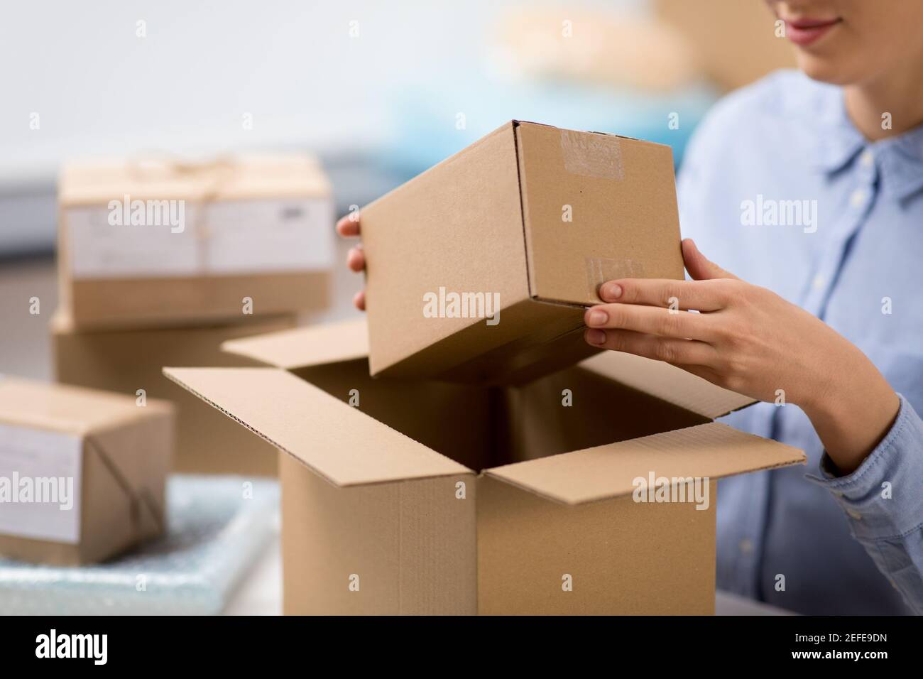 woman packing parcel box at post office Stock Photo - Alamy