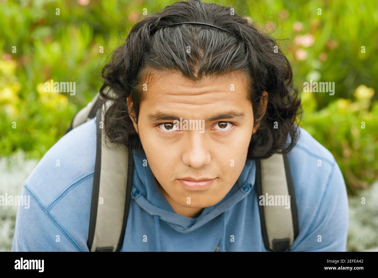 Portrait of a young man carrying a backpack Stock Photo - Alamy