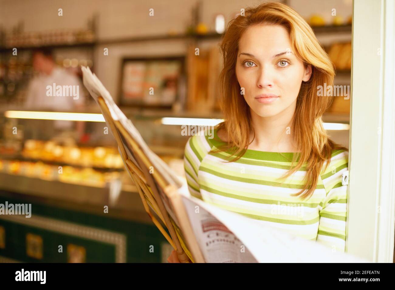 Portrait of a young woman reading a menu card Stock Photo - Alamy