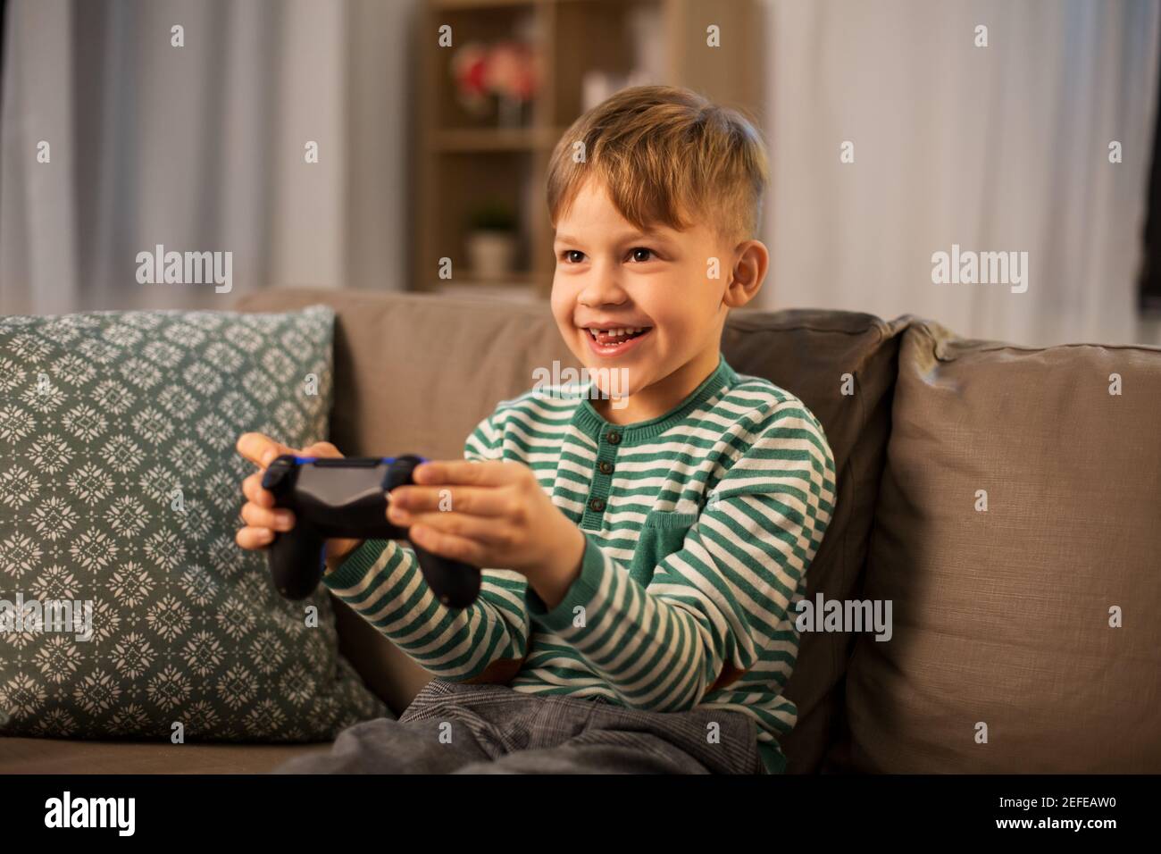little boy with gamepad playing video game at home Stock Photo - Alamy