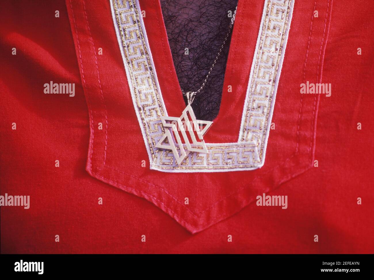 Mid section view of a man wearing a star shaped pendant Stock Photo - Alamy