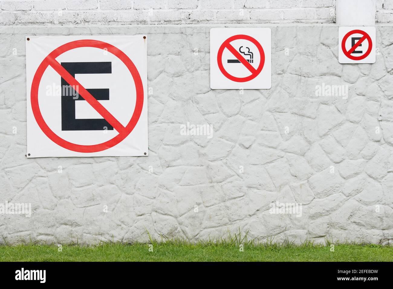 Close-up of no eating sign with no smoking sign on a wall Stock Photo ...