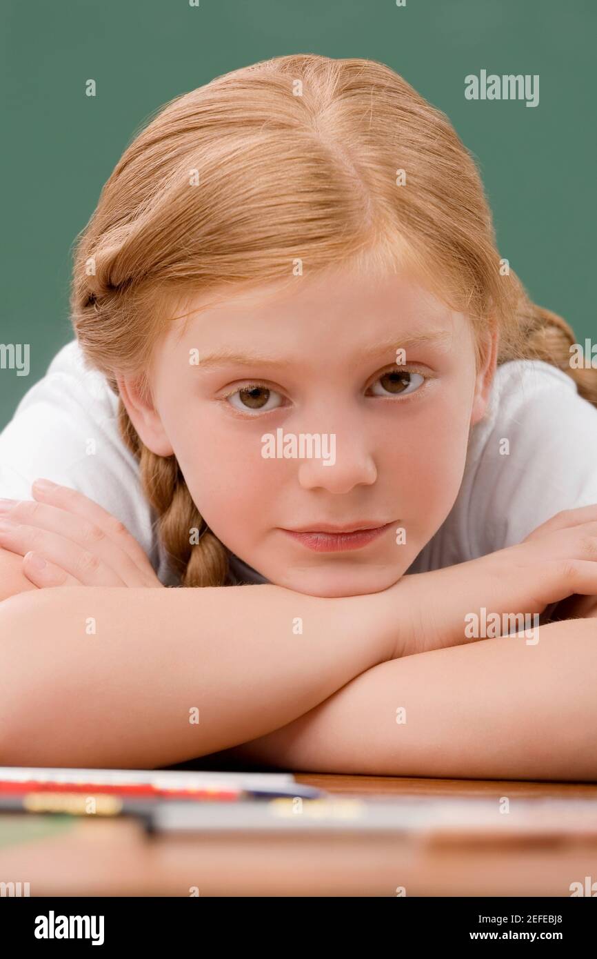 Portrait of a girl leaning on her elbows and thinking Stock Photo - Alamy