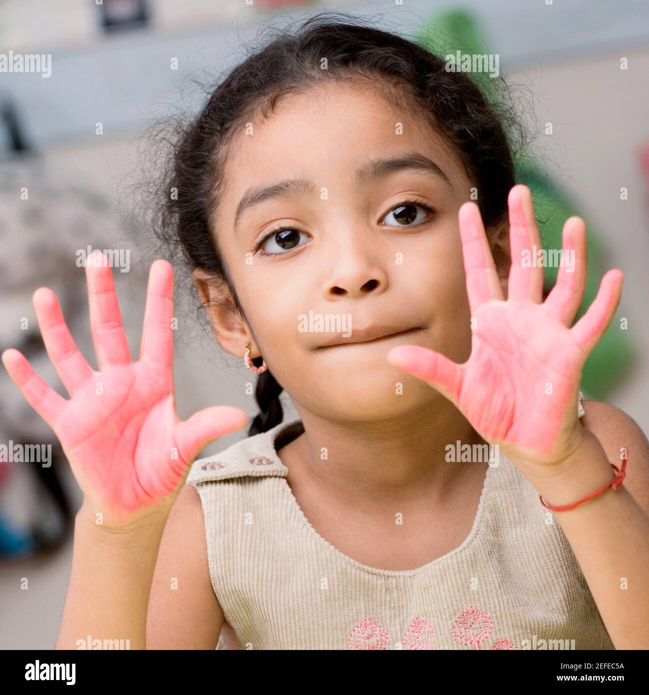 Portrait of a girl showing paint covered hands Stock Photo - Alamy