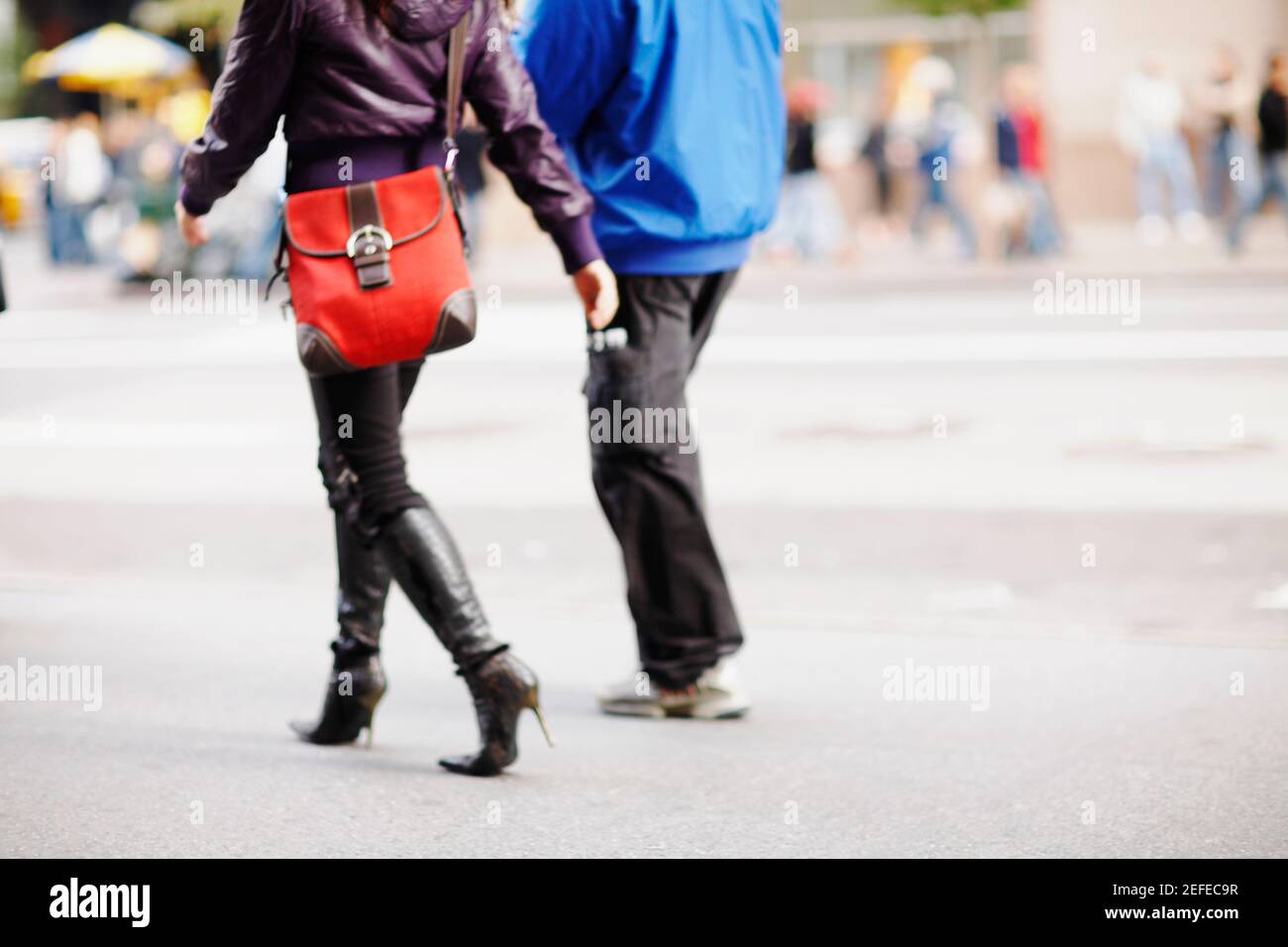 Low section view of two people walking and carrying bags Stock Photo ...