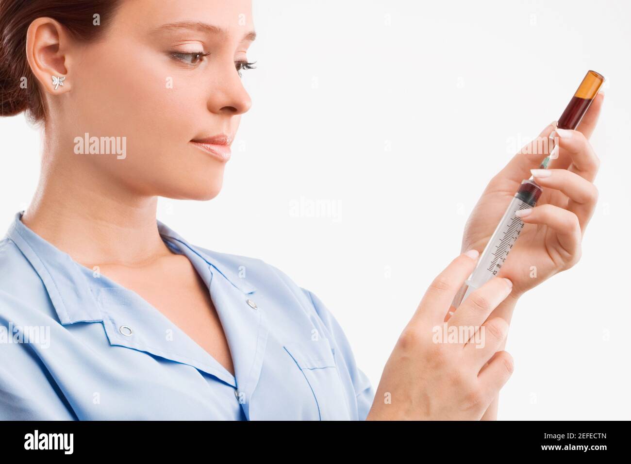 Close up of a female doctor filling a syringe from a vial Stock Photo ...