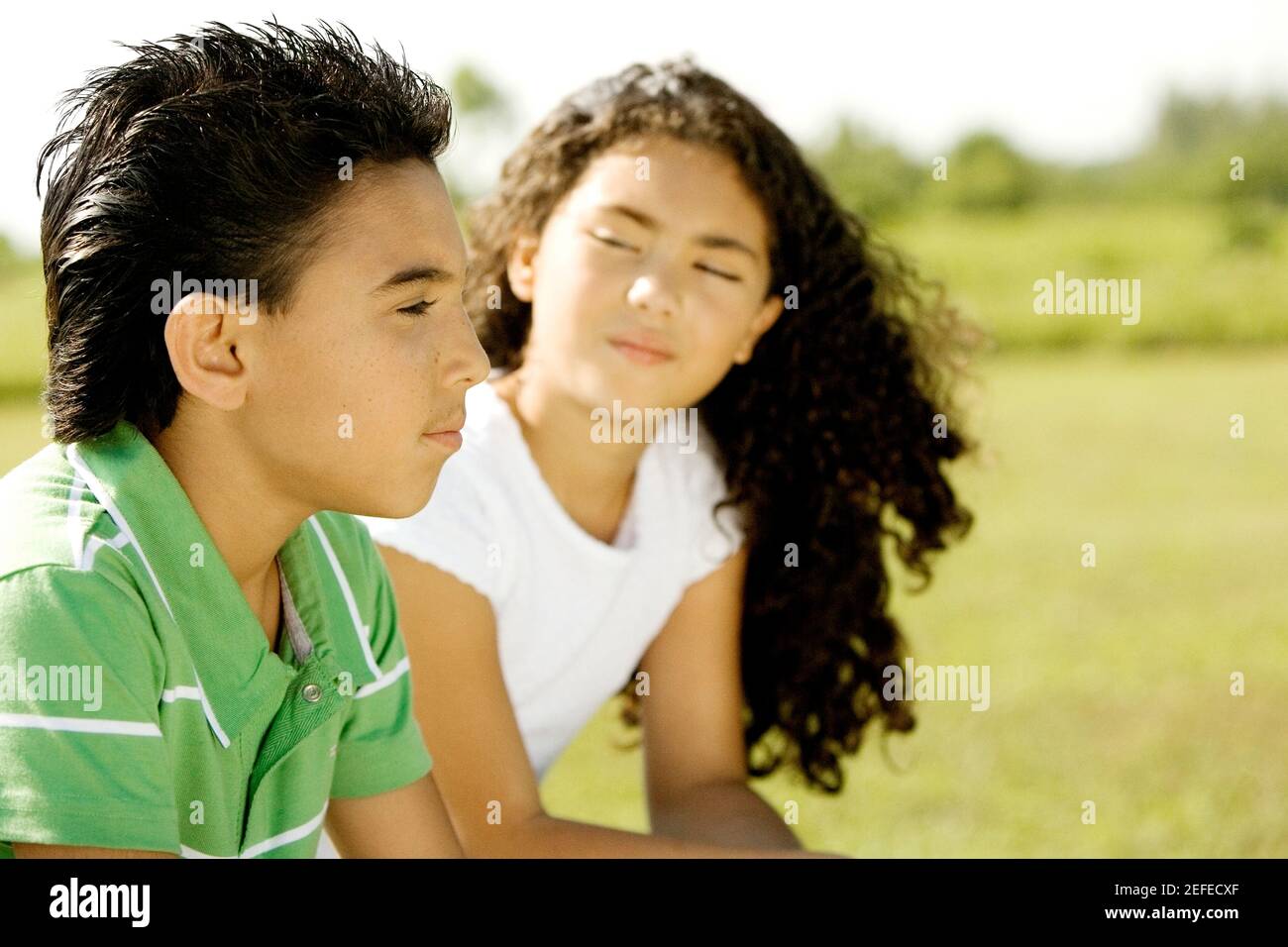 Side profile of a brother and his sister sitting together Stock Photo ...