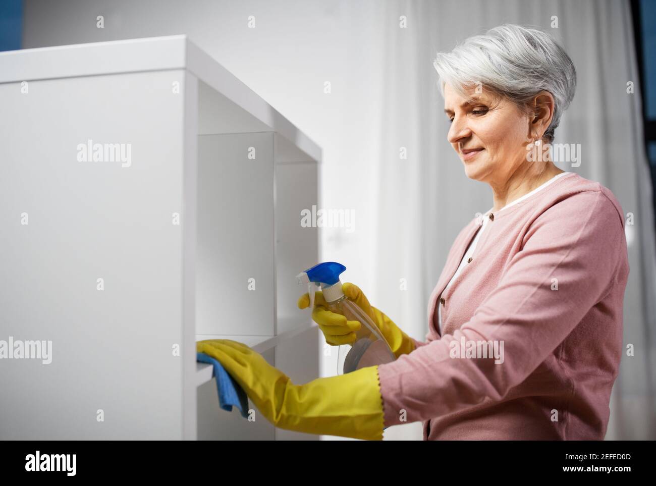 Woman elderly cleaning household hi-res stock photography and images ...